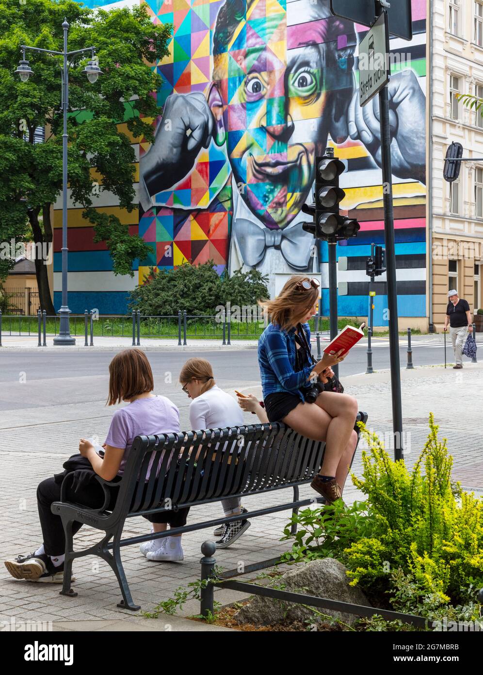 Street scene, mural and reading a book, Europe, Poland Stock Photo - Alamy
