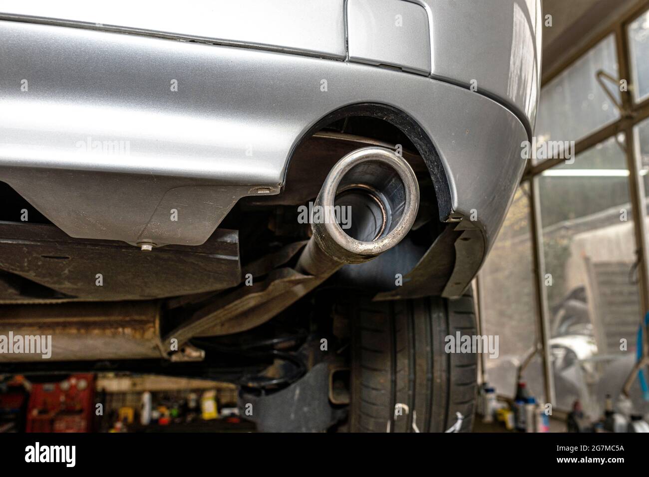 The exhaust system in the car seen from below, visible exhaust tip, the ...