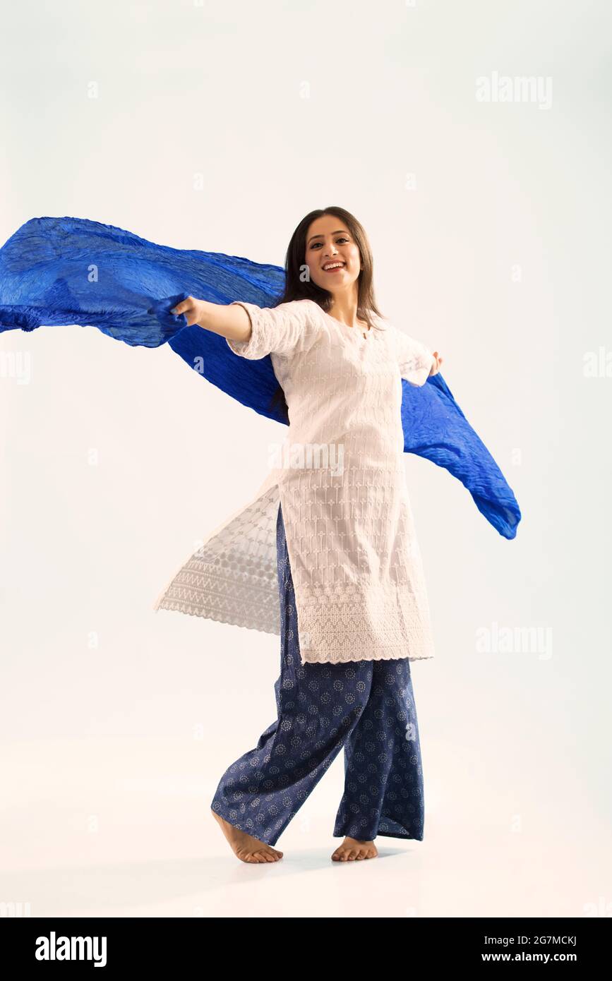A woman in ethnic wear dancing with her chunni Stock Photo - Alamy