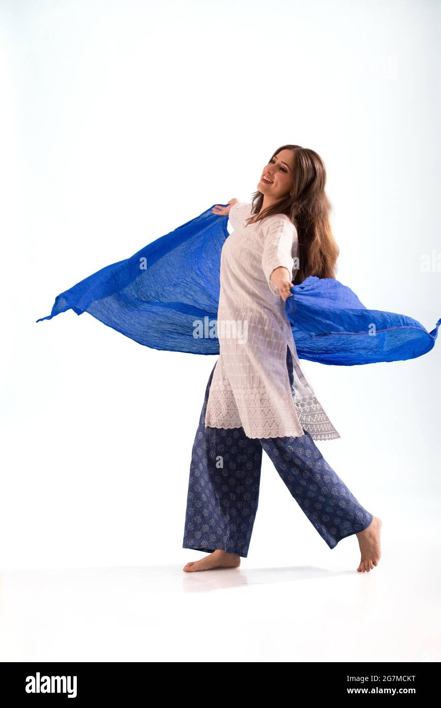A woman in ethnic wear dancing with her chunni Stock Photo - Alamy