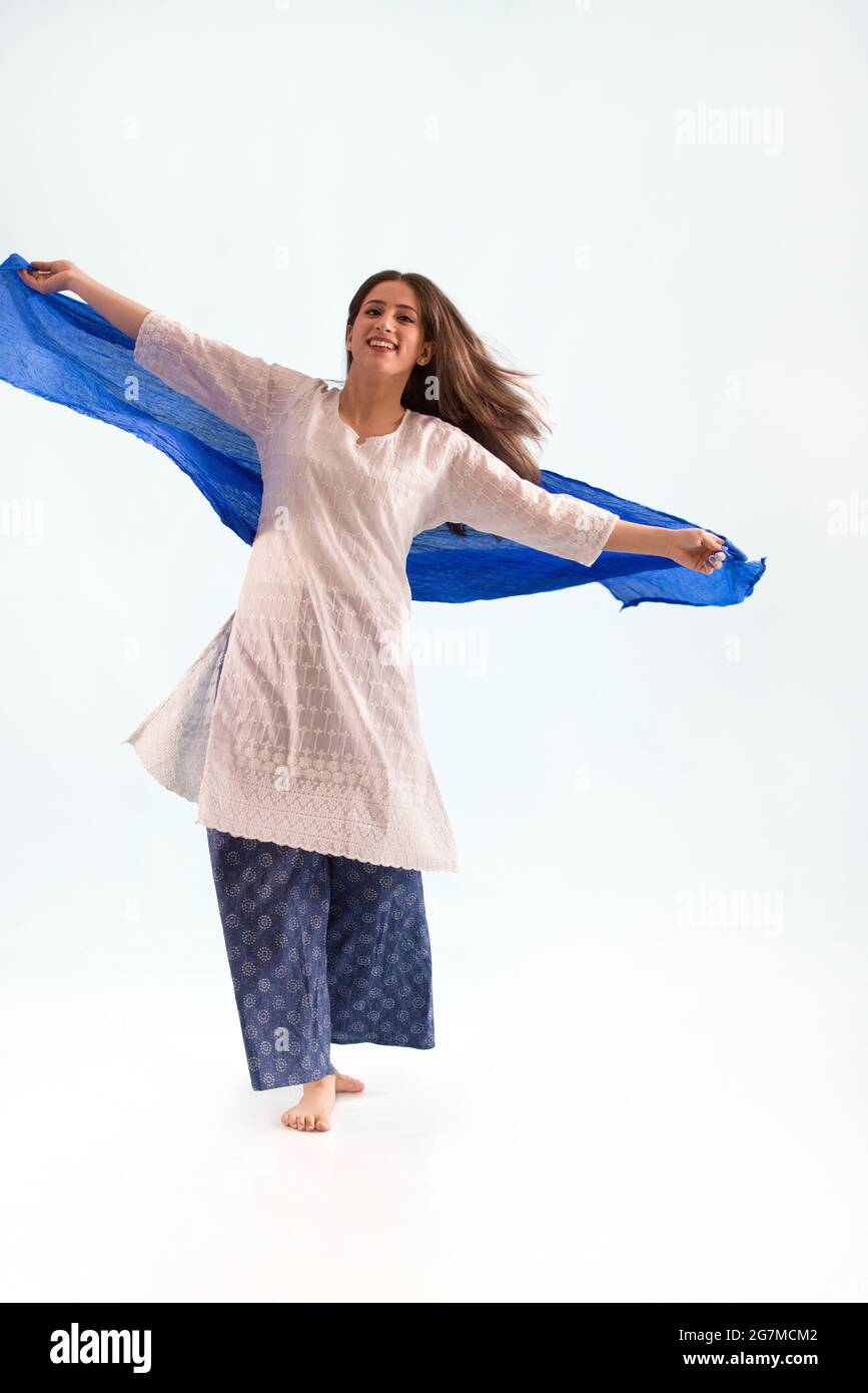 A woman in ethnic wear dancing with her chunni Stock Photo - Alamy