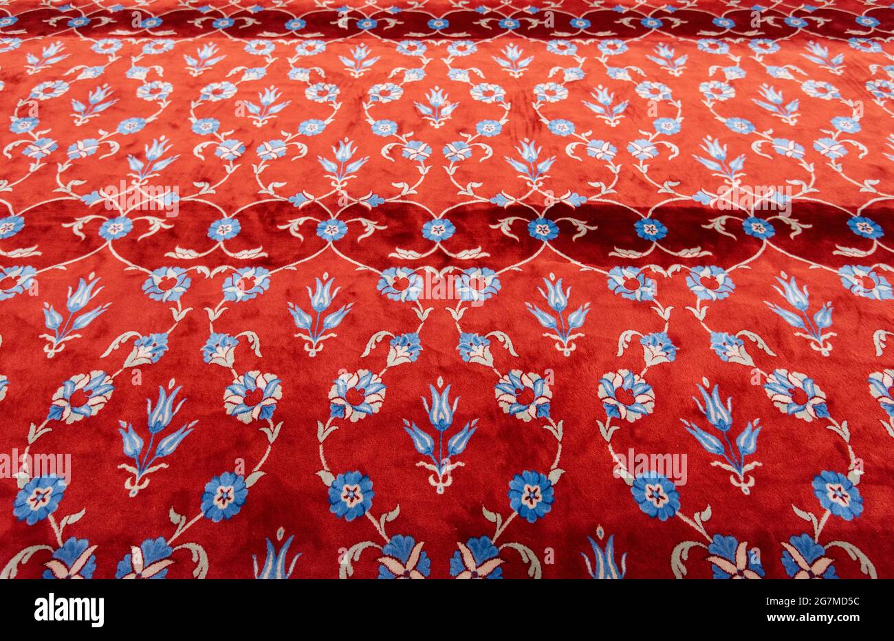 Part of red carpet or rug in muslim mosque. Prayer mat in the Blue ...