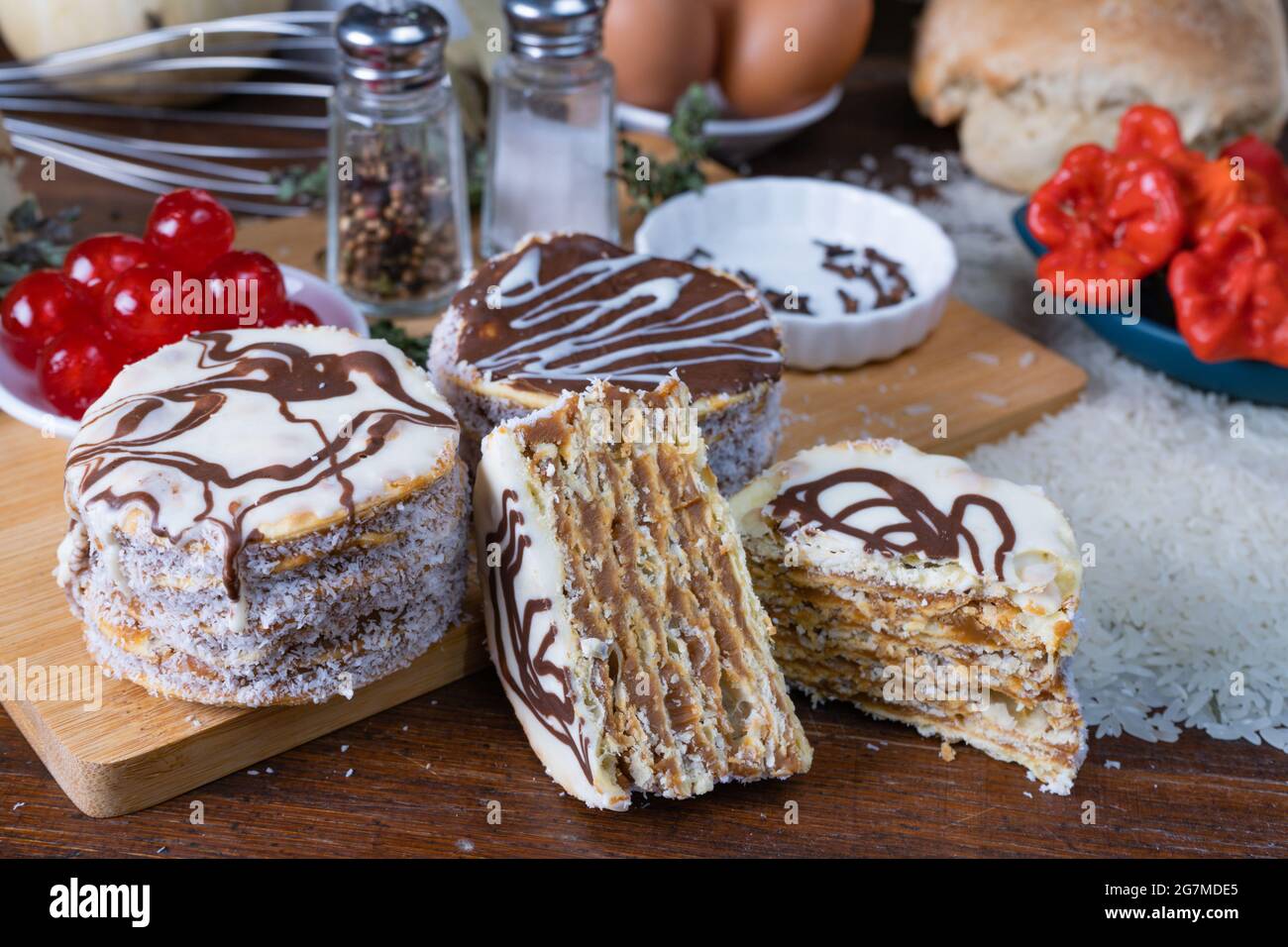 Baked cakes with different toppings on the table with baking ...