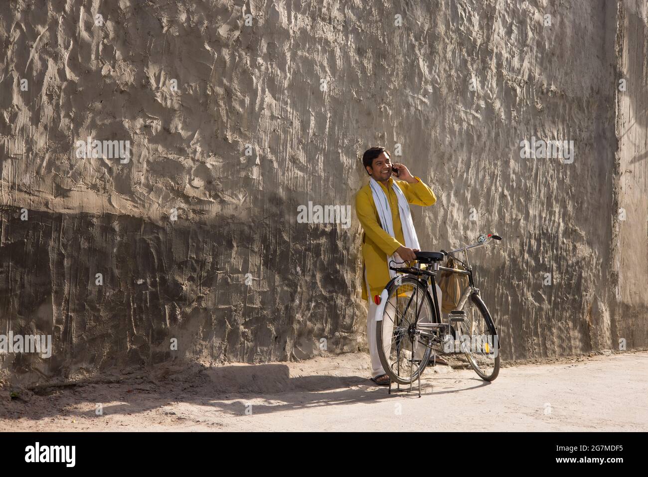 A HAPPY VILLAGER STANDING AND TALKING ON MOBILE WHILE STANDING Stock ...