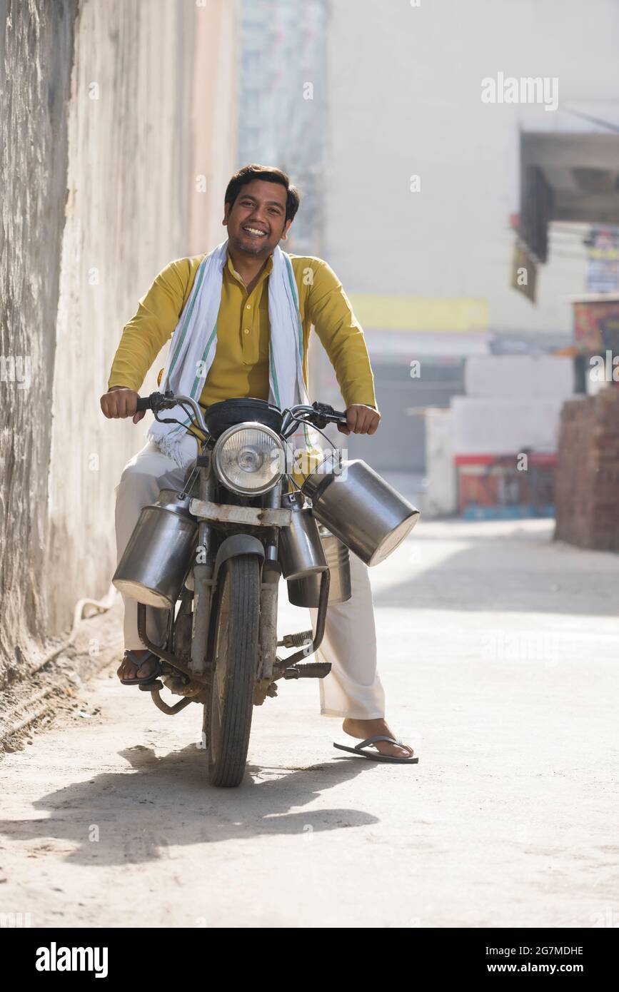 A RURAL MILKMAN HAPPILY POSING WHILE ON HIS WAY TO DELIVER MILK Stock ...