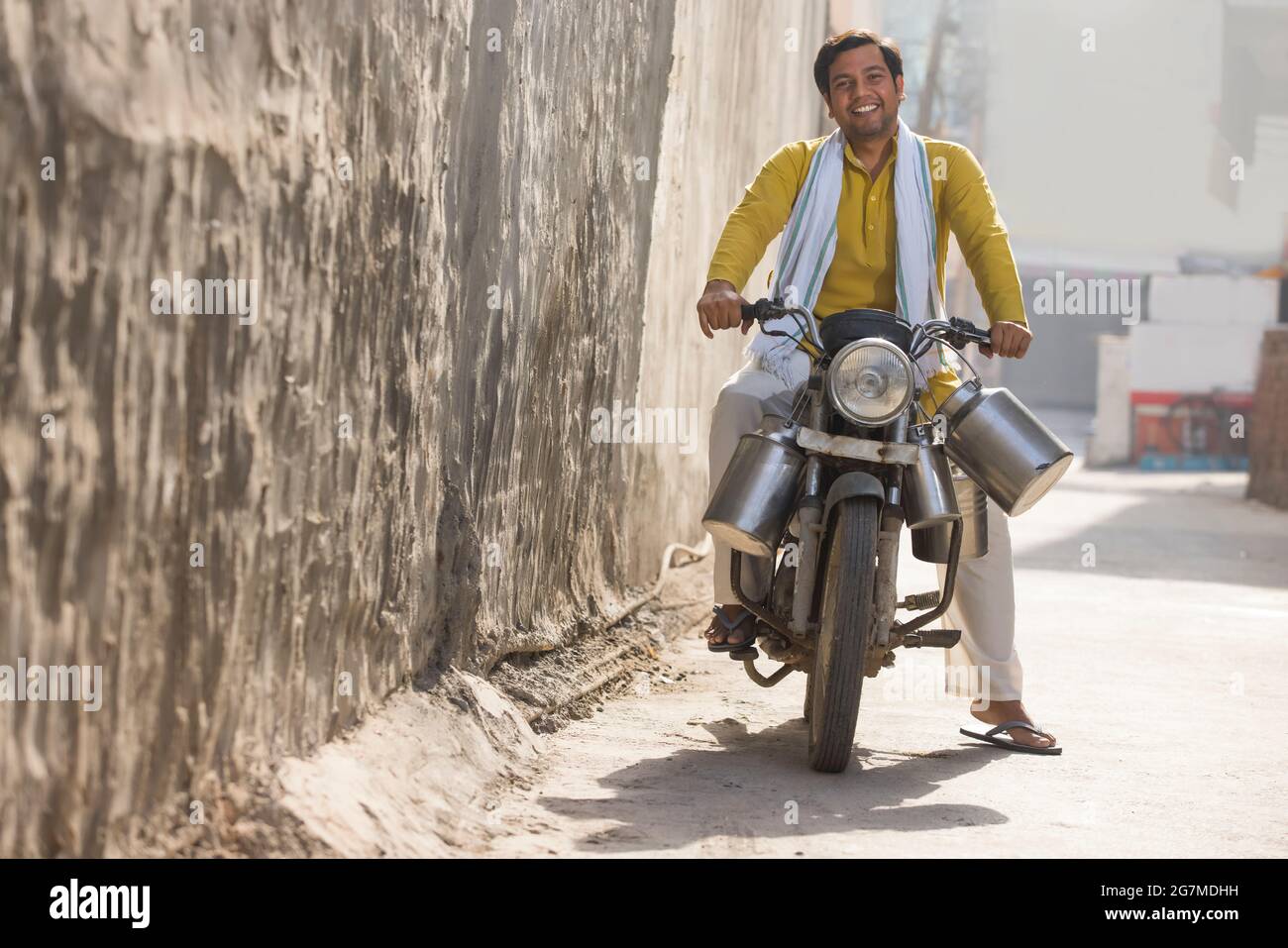 Indian milkman does his hi-res stock photography and images - Alamy