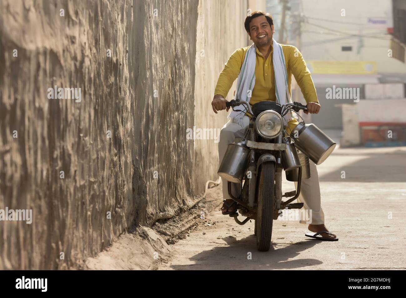 A VILLAGE MILKMAN LOOKING AT CAMERA AND SMILING Stock Photo - Alamy