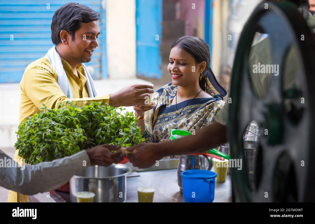 A RURAL HUSBAND AND WIFE SHARING STREET JUICE TOGETHER Stock Photo - Alamy