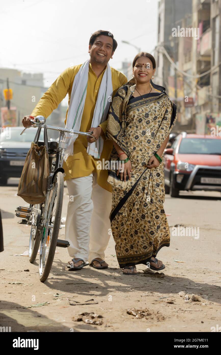 A RURAL COUPLE HAPPILY WALKING TOGETHER ON A BUSY ROAD Stock Photo - Alamy