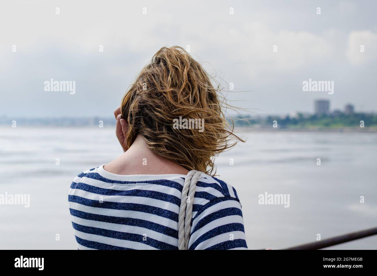 Woman looking out to sea Stock Photo - Alamy
