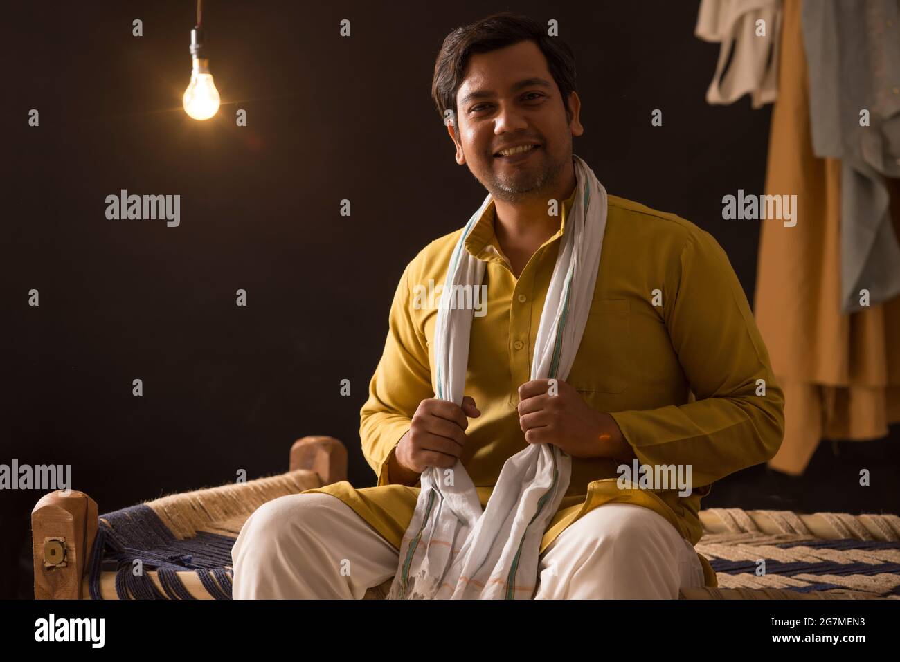 A CHEERFUL VILLAGER SITTING AND LOOKING AT CAMERA AT NIGHT Stock Photo ...