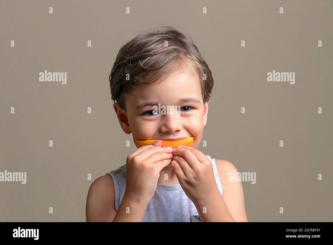 little child eating fruit. handsome and happy boy eating ripe, sweet ...