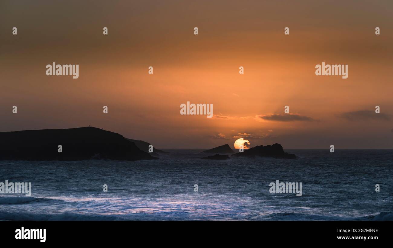 A panoramic view of an intense spectacular sunset over Fistral Bay in ...