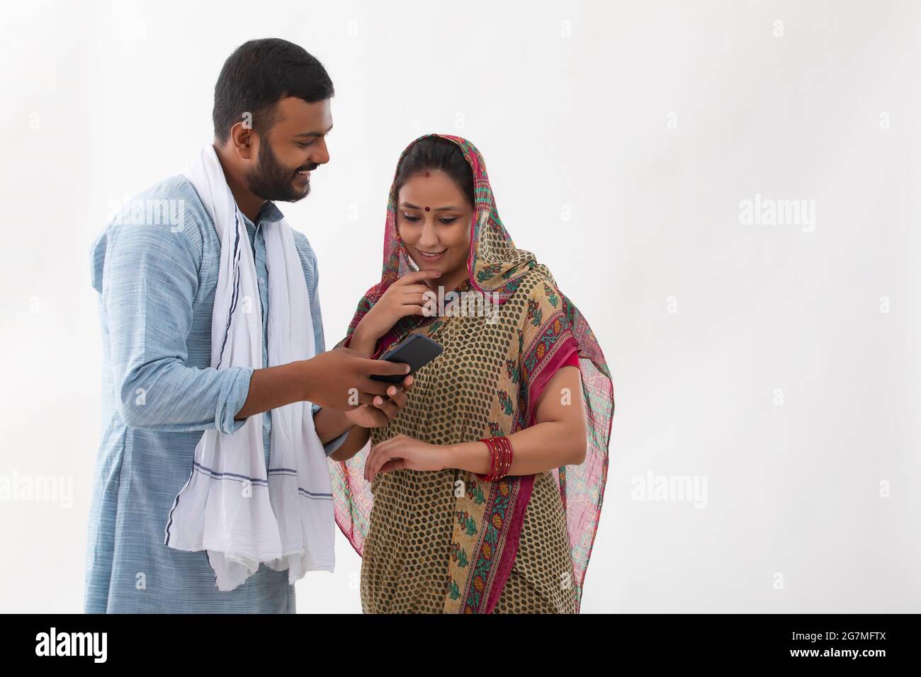 PORTRAIT OF A RURAL HUSBAND SHOWING HIS MOBILE TO WIFE Stock Photo - Alamy