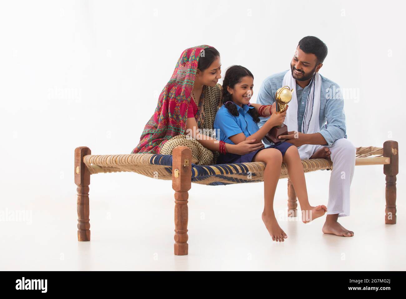 PORTRAIT OF A RURAL GIRL PROUDLY SHOWING PARENTS HER TROPHY Stock Photo ...