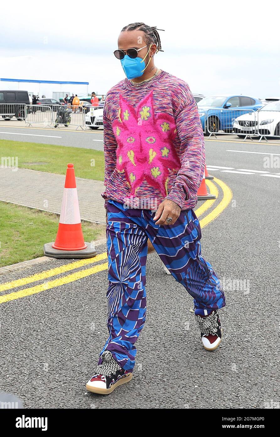 Mercedes' Lewis Hamilton arrives at the paddock ahead of the British ...