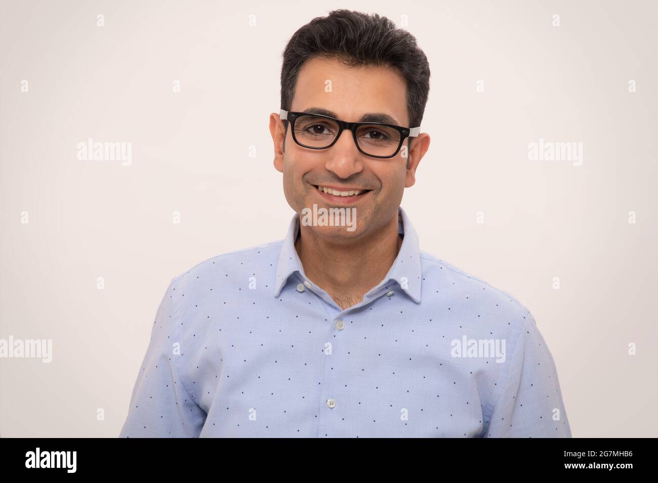 A HAPPY CORPORATE EMPLOYEE WEARING SPECS LOOKING AT CAMERA Stock Photo ...