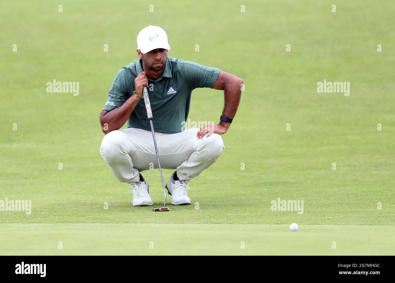 England's Aaron Rai lines up a putt on the 2nd green during day one of ...