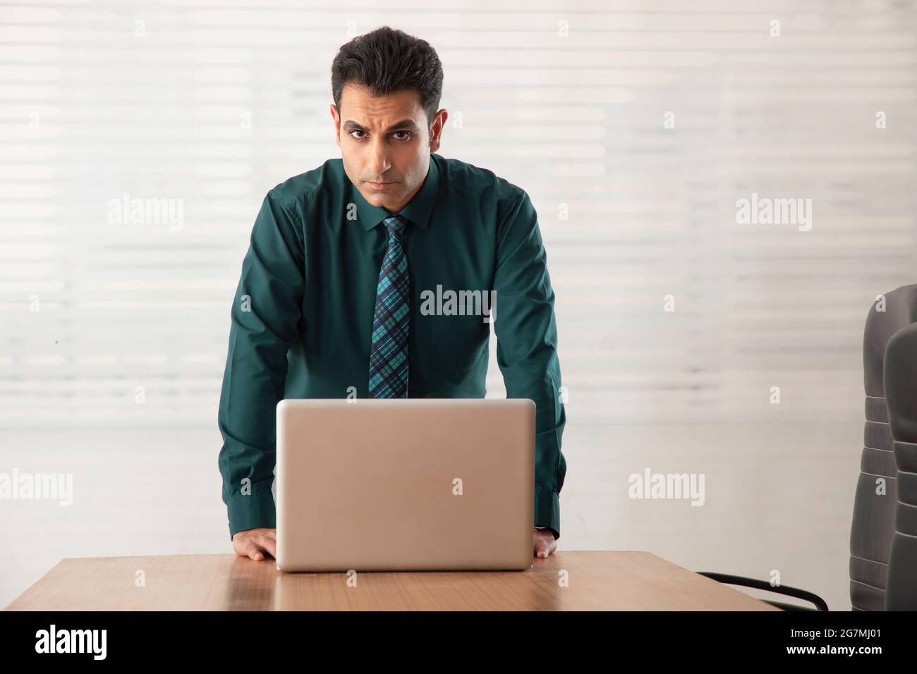 A SERIOUS CORPORATE PROFESSIONAL STANDING AND LOOKING AT CAMERA Stock ...