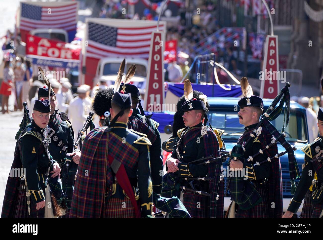 Cast take part in a parade scene on St Vincent Street in Glasgow ...