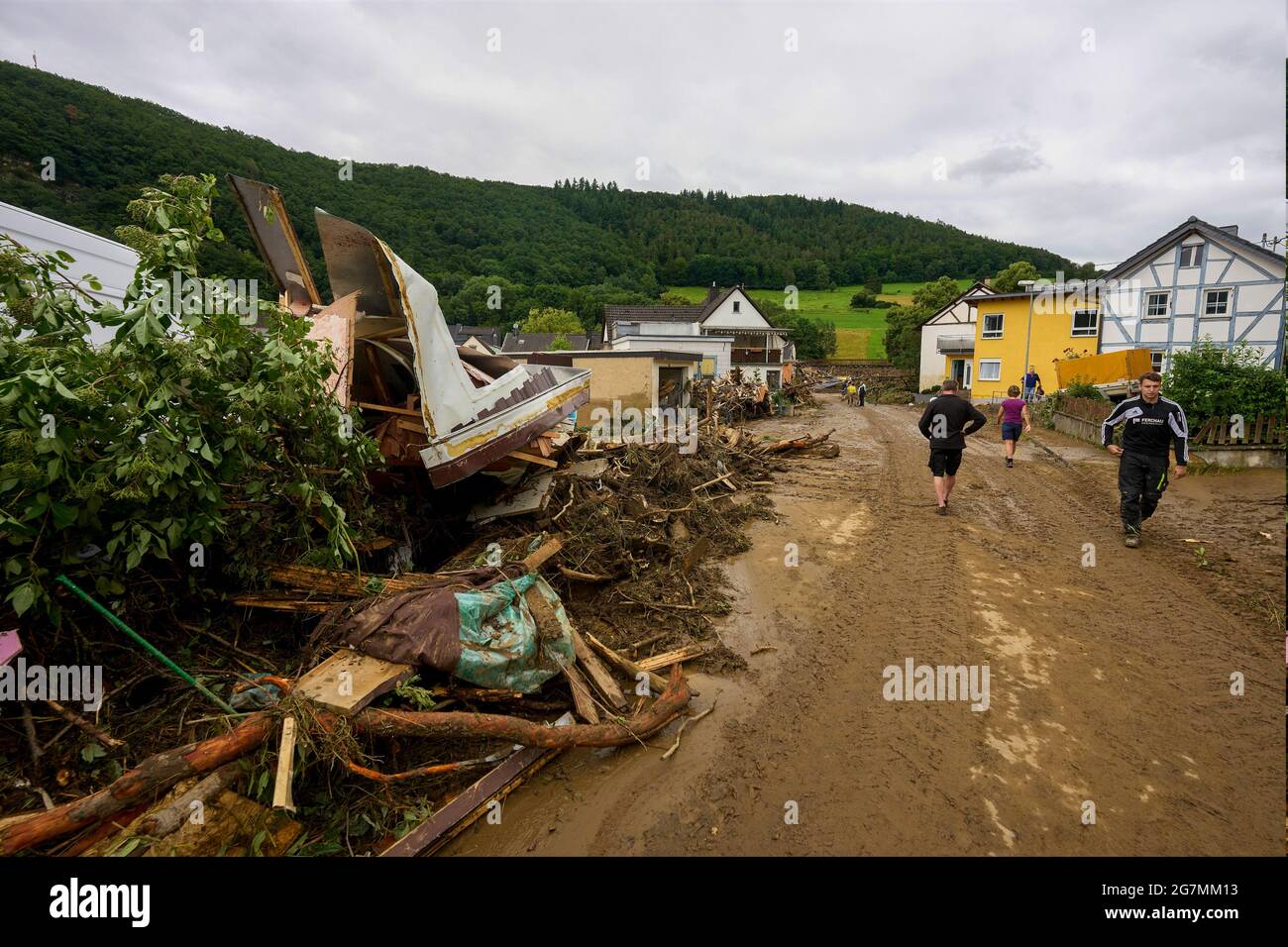 Schuld, Germany. 15th July, 2021. People walk on a street past ...