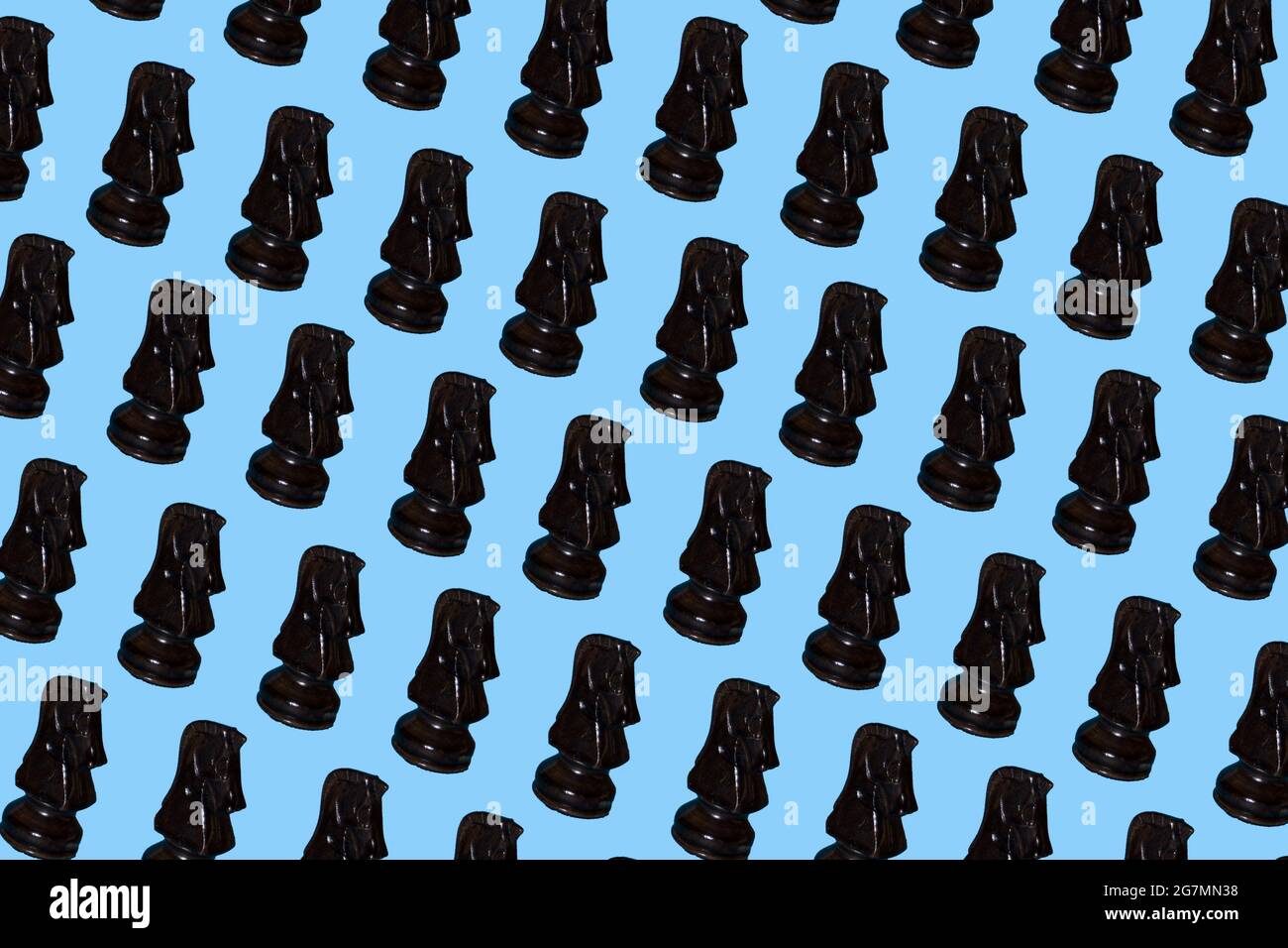 Black, dark knight chess piece multiplied on soft, trendy pastel blue ...