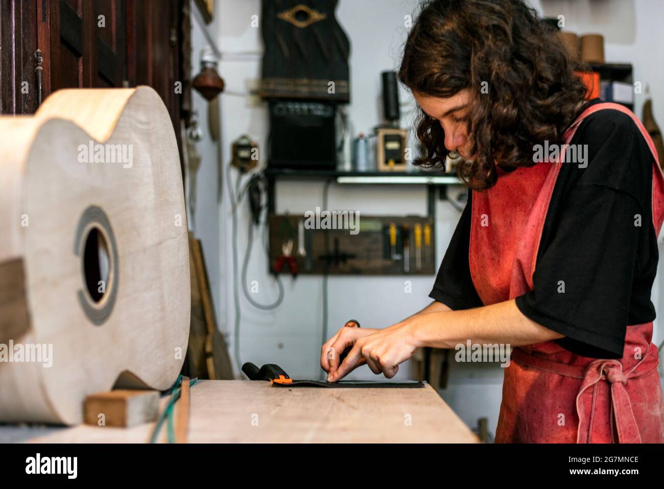 woman luthier making guitars in her musical instrument workshop Stock ...