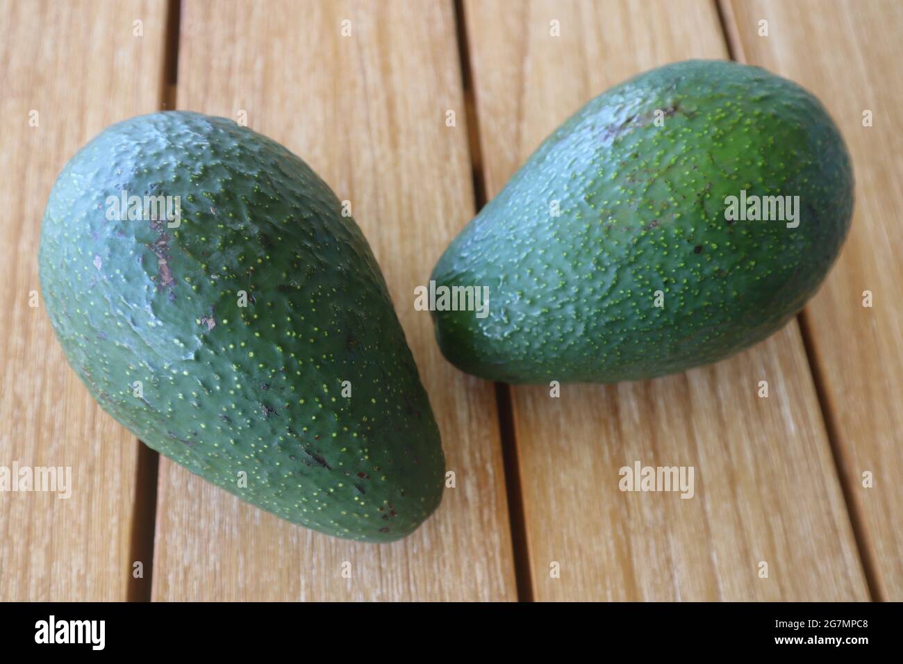 Closeup of the big ripe green avocados on a wooden table Stock Photo ...