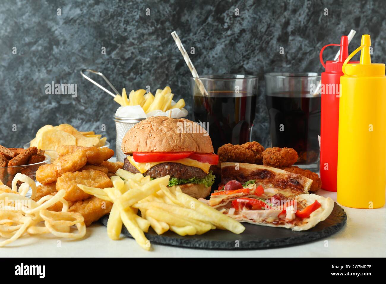 Concept of fast food against black smokey background Stock Photo - Alamy