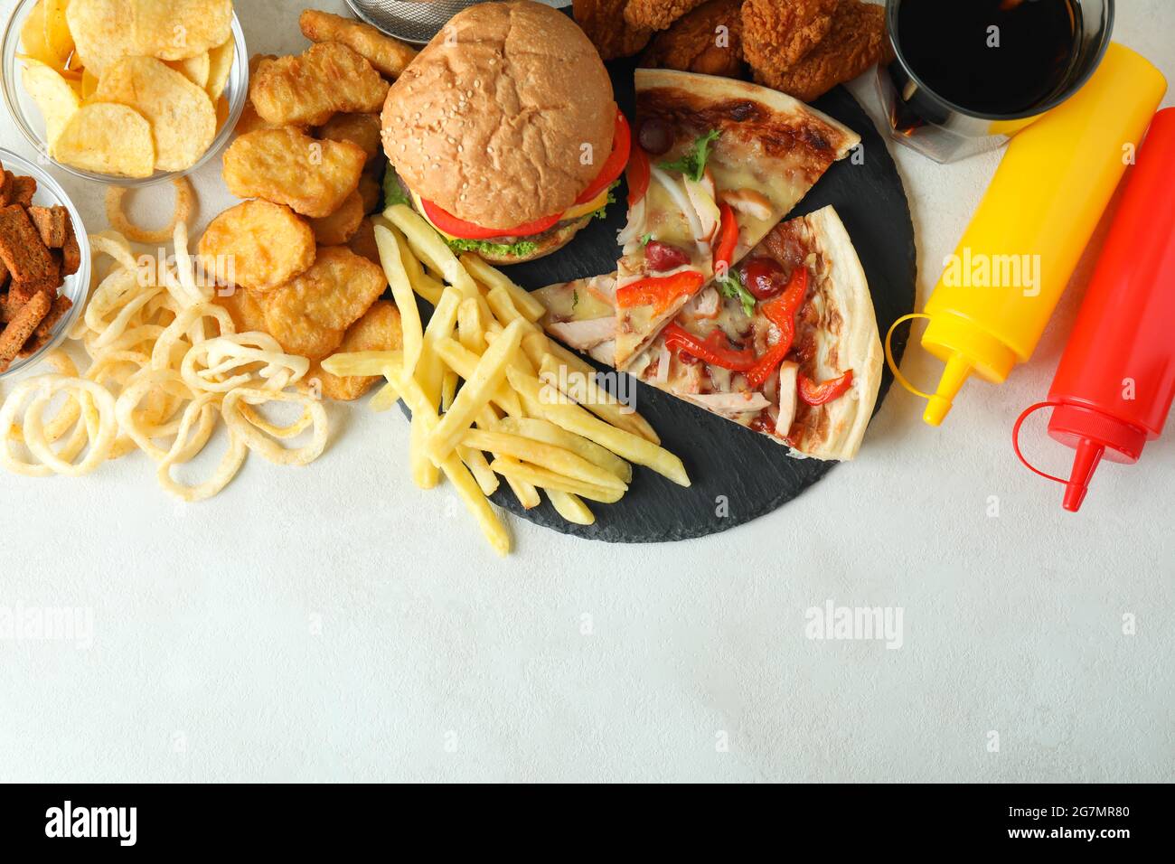Concept of fast food on white textured table Stock Photo - Alamy