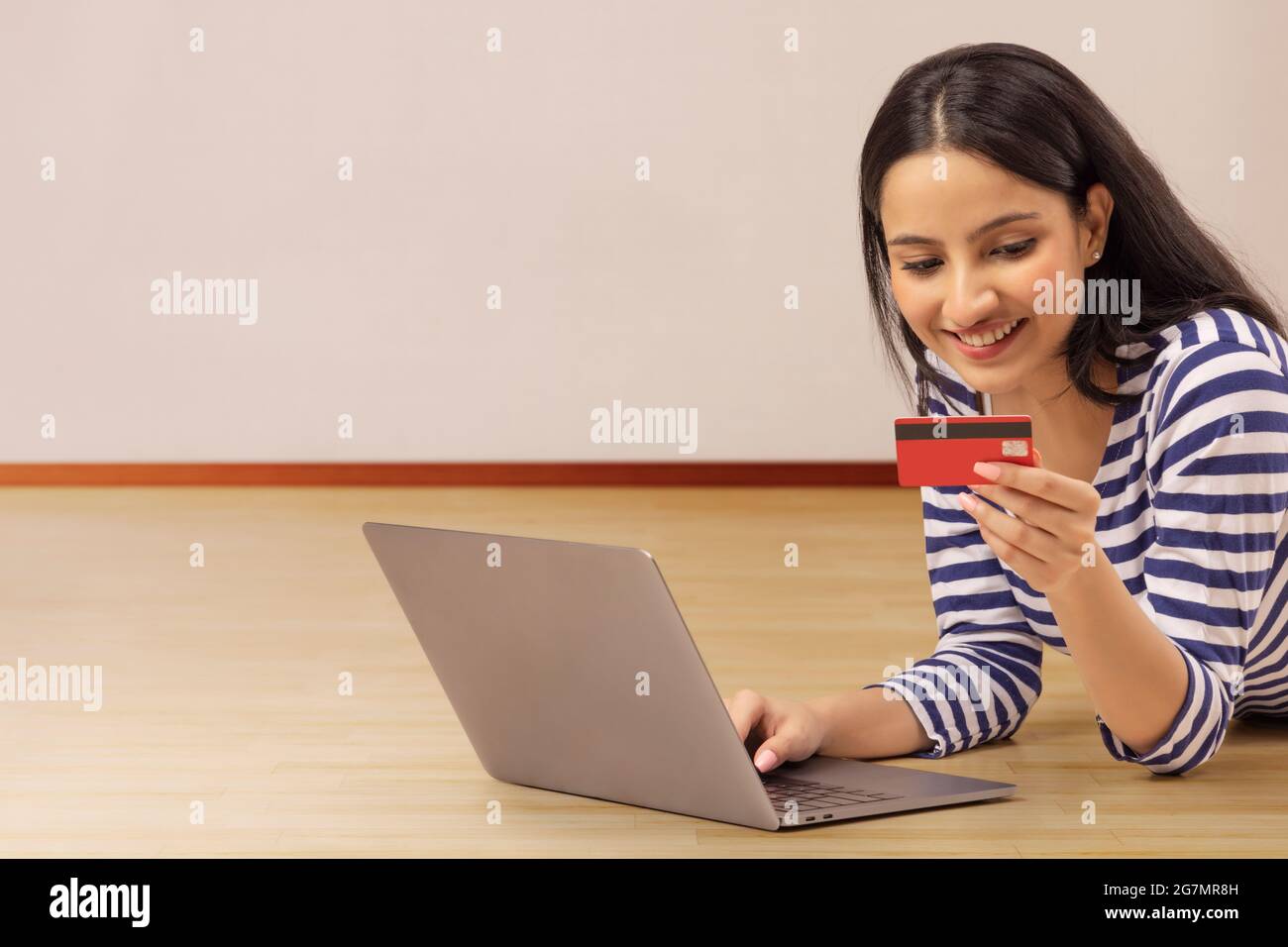 A TEENAGER USING DEBIT CARD TO DO ONLINE TRANSACTION AT HOME Stock ...