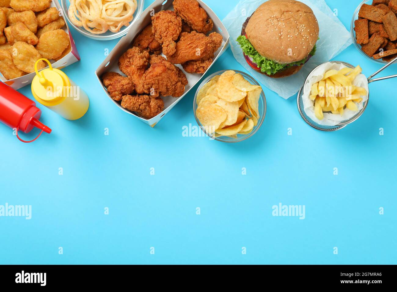 Concept of fast food on blue background Stock Photo - Alamy