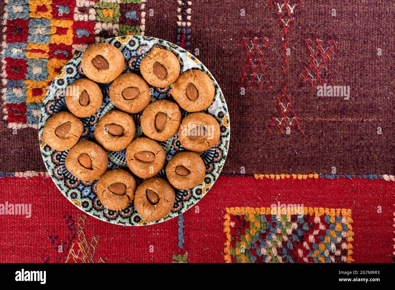 Traditional Moroccan handmade cookies in a ceramic plate on a colorful ...