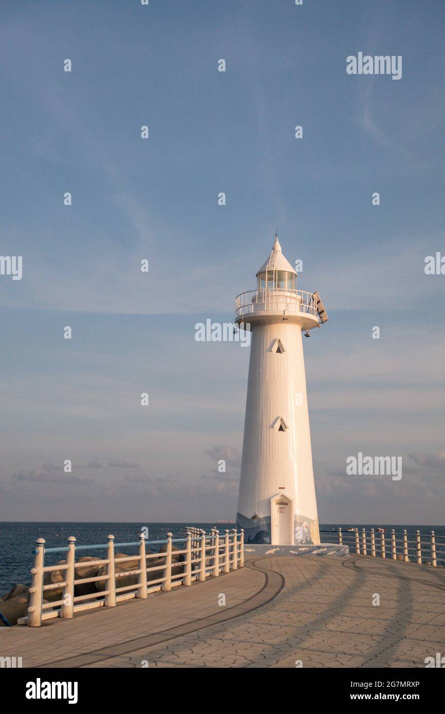 Lighthouse on the pier at sunset dusk scenic landscape wallpaper Stock ...