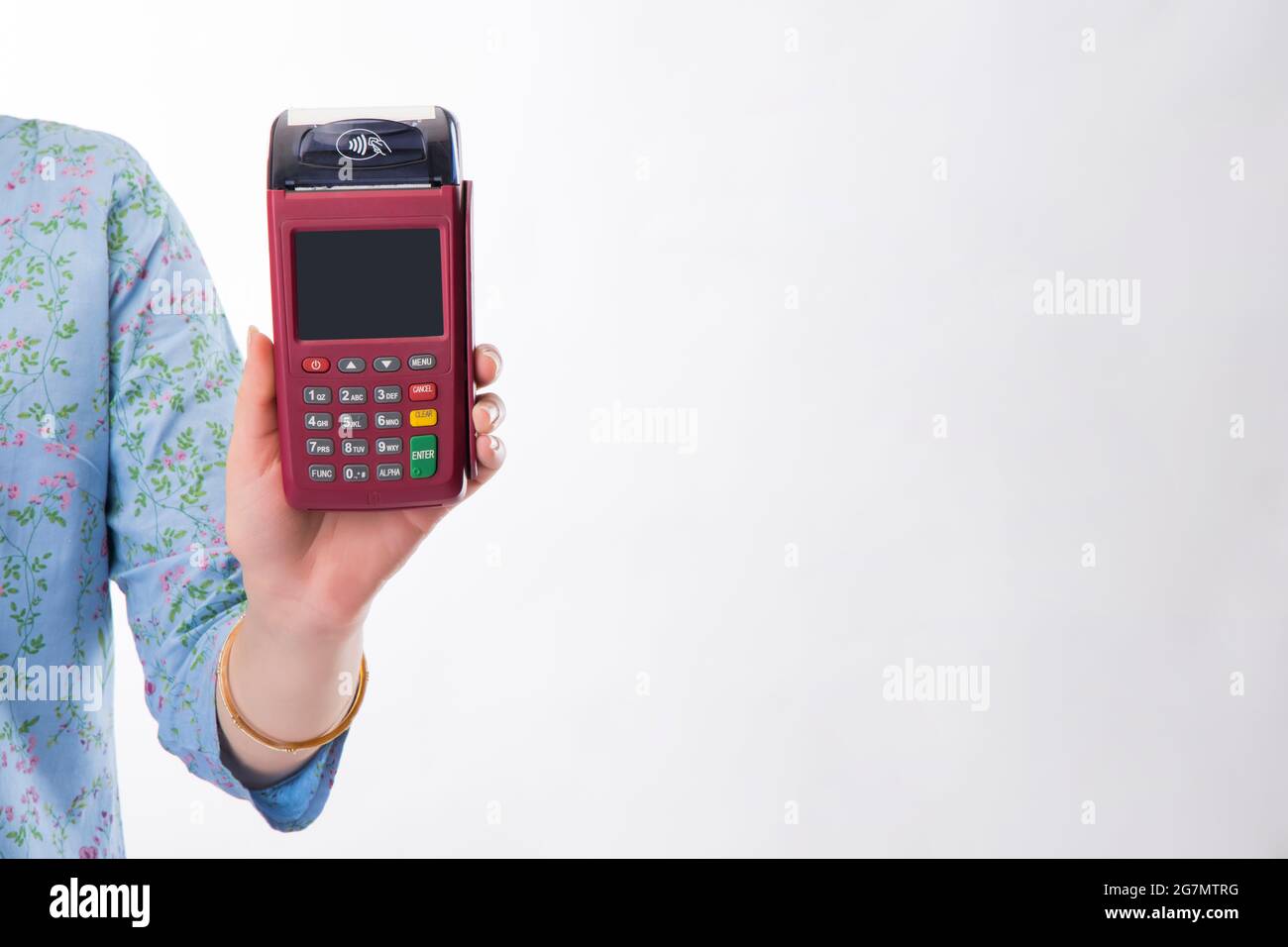 A human hand holding a swipe machine Stock Photo - Alamy