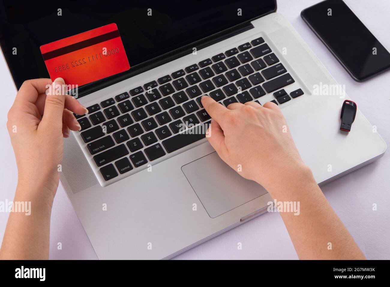 Human hand operating laptop with a card in another hand Stock Photo - Alamy