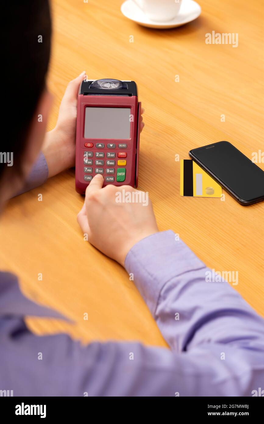 A human hand entering code in swipe machine Stock Photo - Alamy