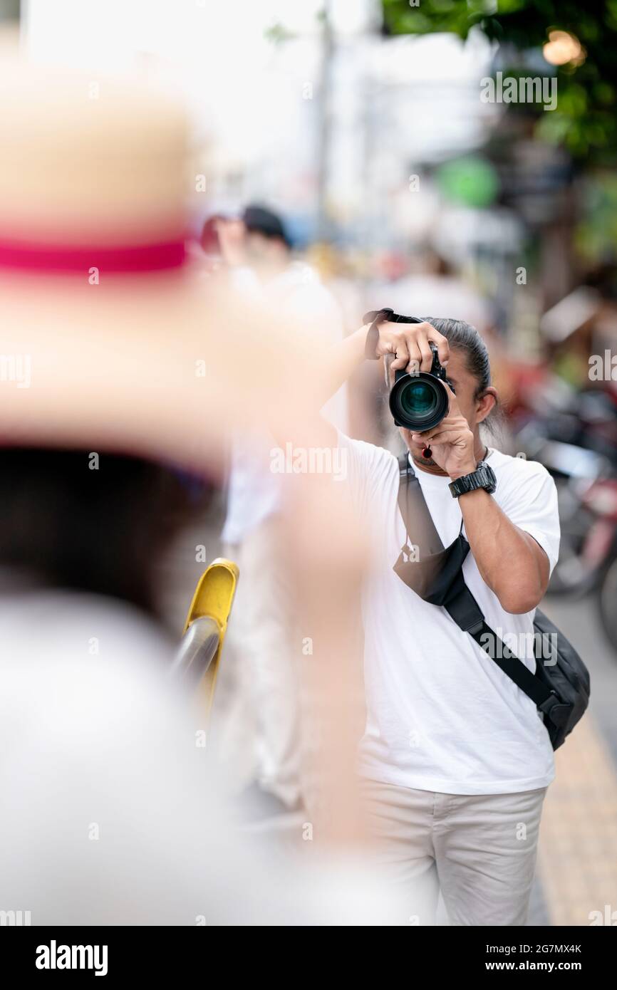Professional Asian Camera man focus on the image with his mirrorless ...