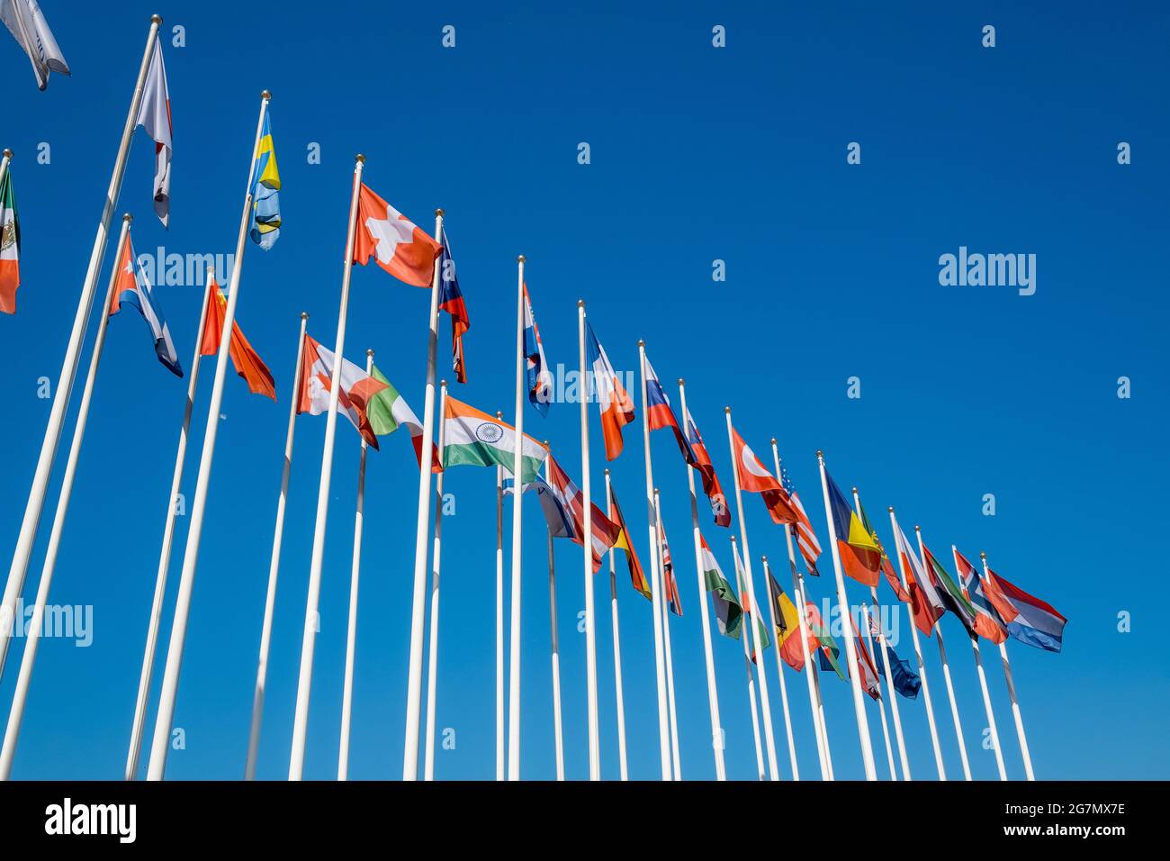 Different flags fluttering on flagpoles Stock Photo - Alamy