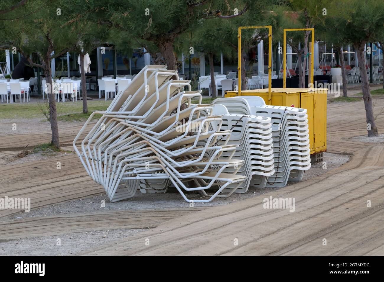 Beach with folded sun loungers in the morning Stock Photo - Alamy