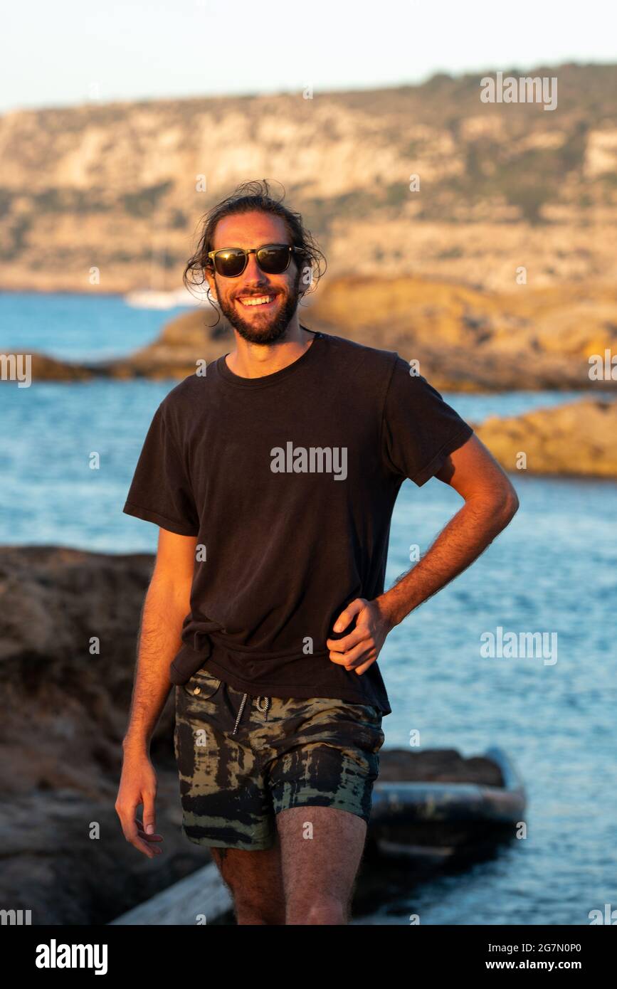 Handsome young man from Argentina on the beach of the Mediterranean sea ...