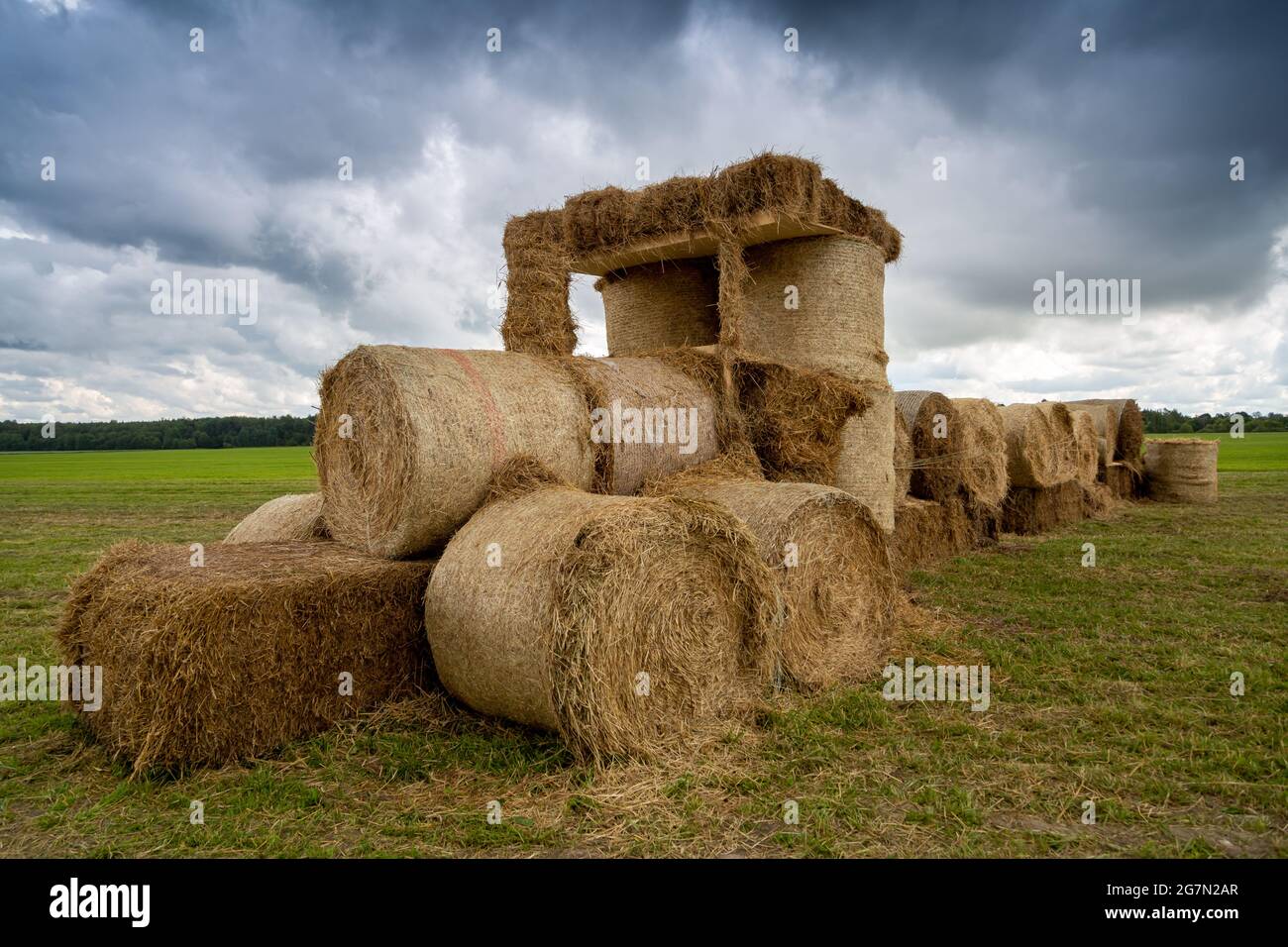 tractor from straw bales in the field Stock Photo - Alamy