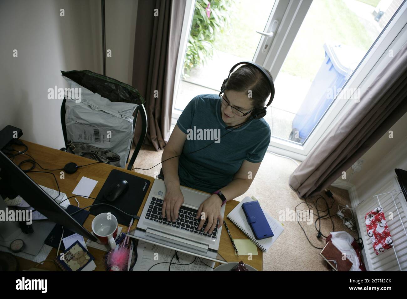 Working mother continues working remotely from home during 2021 ...