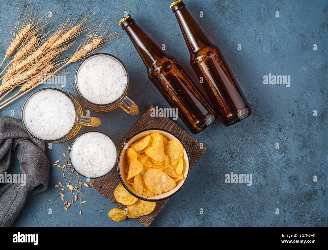 Beer, chips and wheat spikelets on a dark blue background Stock Photo ...