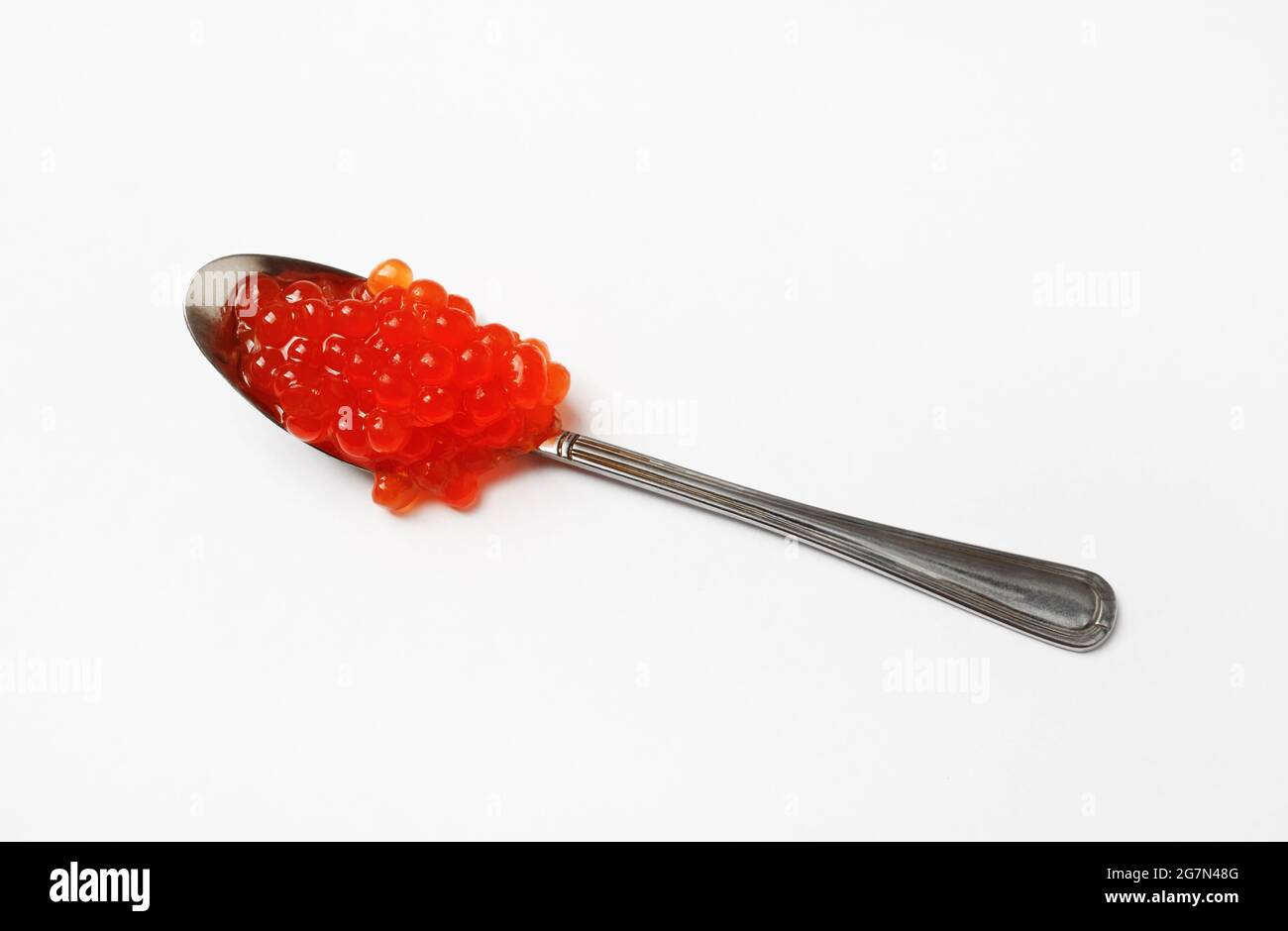 Red caviar in spoon on white table background Stock Photo - Alamy