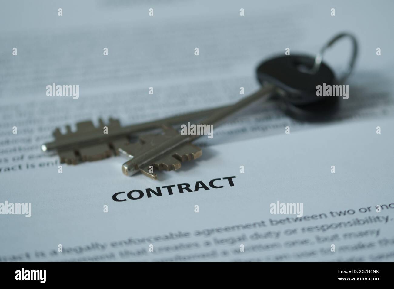 There is a contract and car keys on the table, the emphasis is on the ...