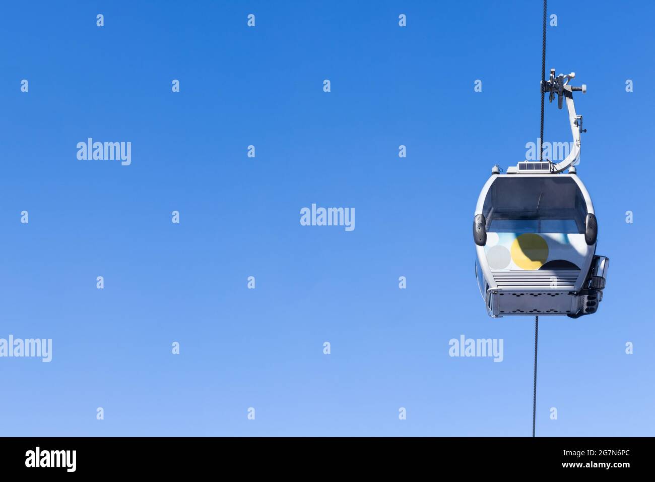 One cabin cableway against the blue sky in the air. Copy space on the ...