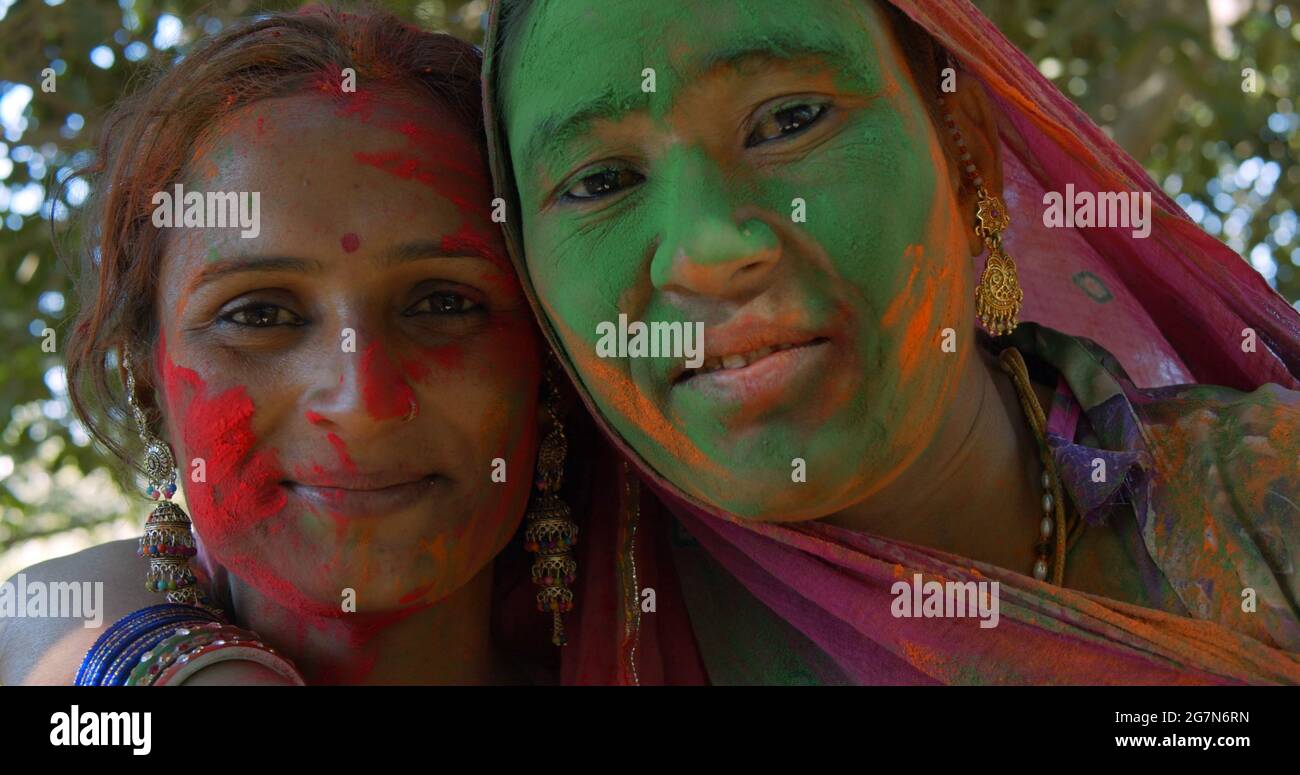 Beautiful shot of Indian women with colorful faces at the Festival of ...
