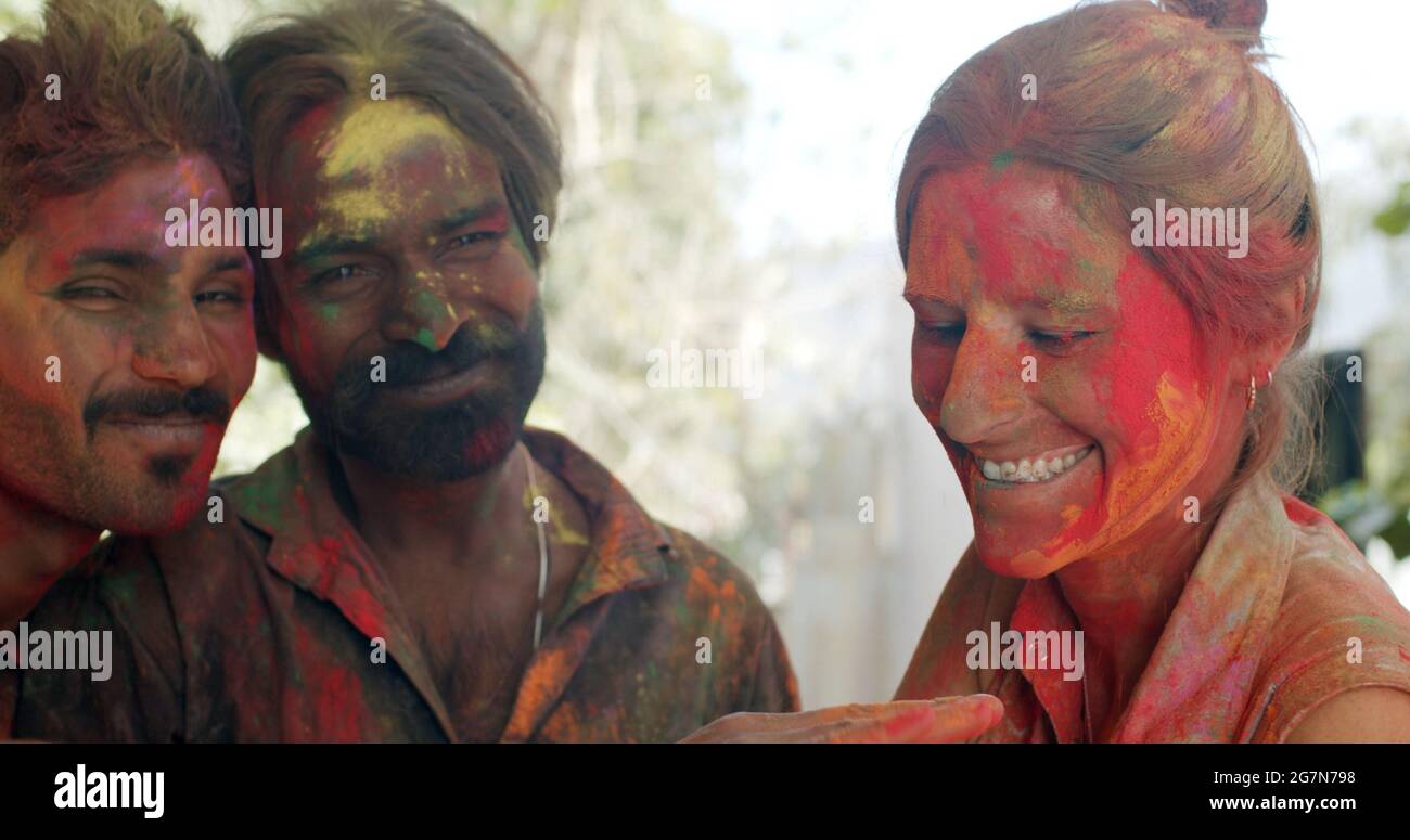 Beautiful shot of friends with colorful faces having fun at the ...