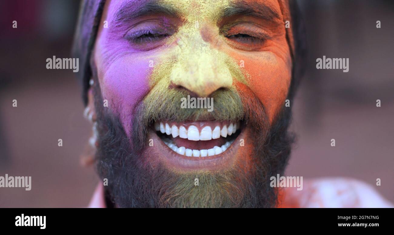 Closeup shot of an Indian beard man with a colorful face on the ...
